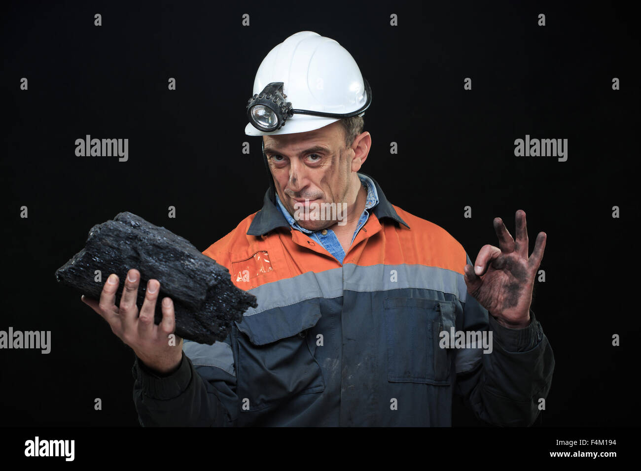 coalminer holds out a large chunk of energy rich coal Stock Photo - Alamy