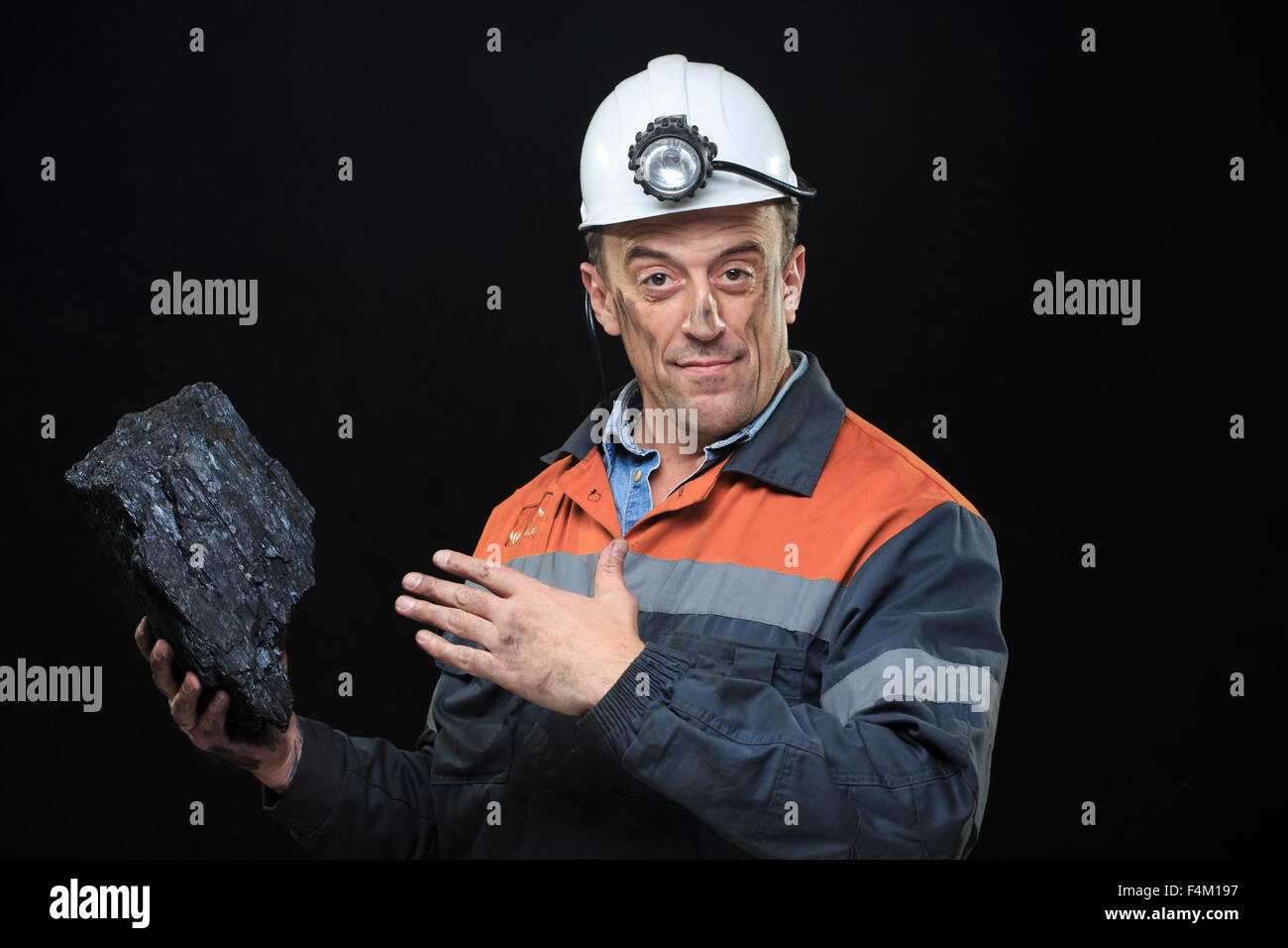 coalminer holds out a large chunk of energy rich coal Stock Photo - Alamy