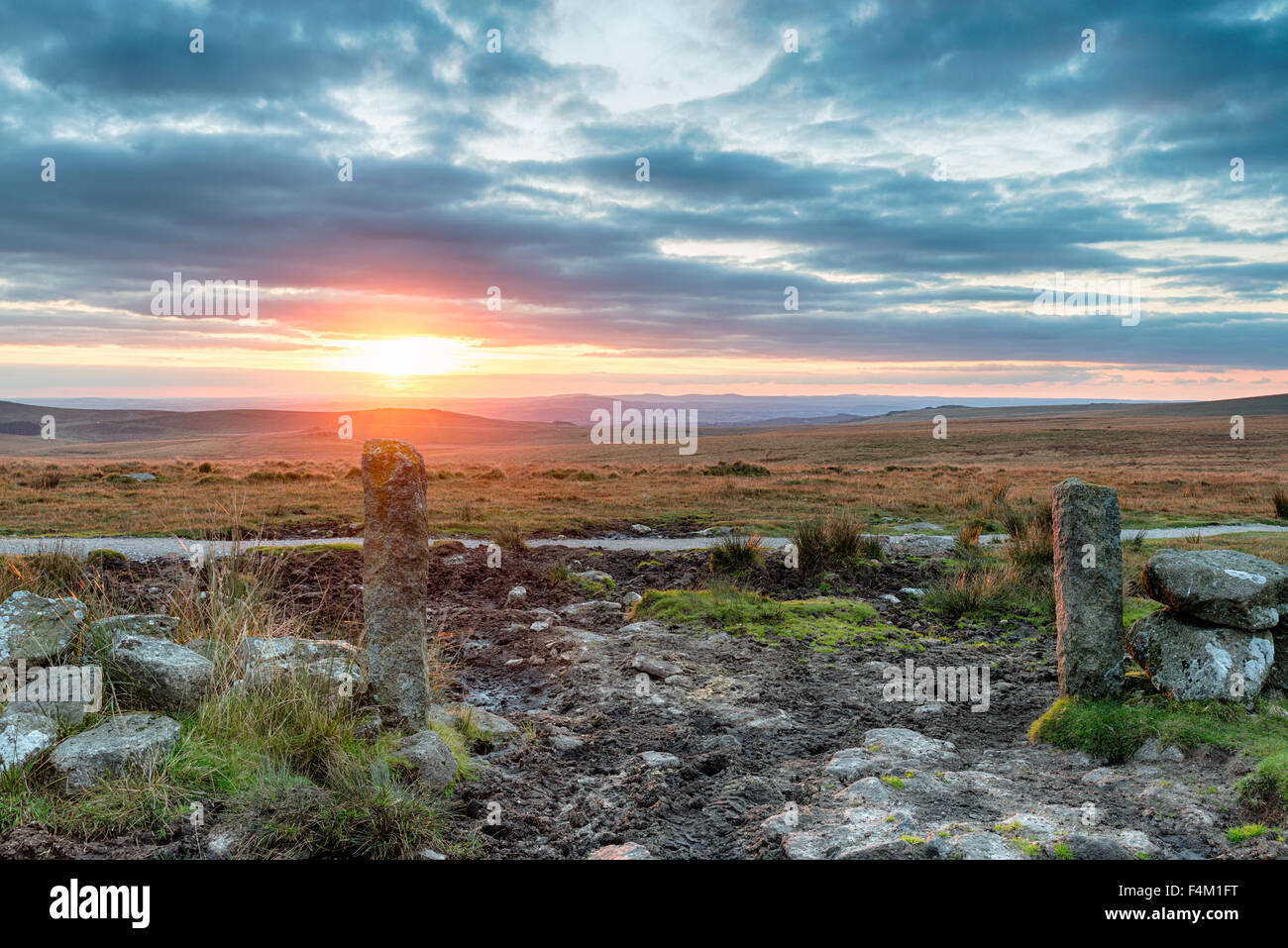 Beautiful sunset over an old granite gateway on a moorland track near ...