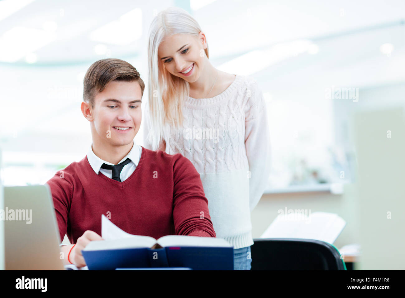 Students reading together in library hi-res stock photography and ...