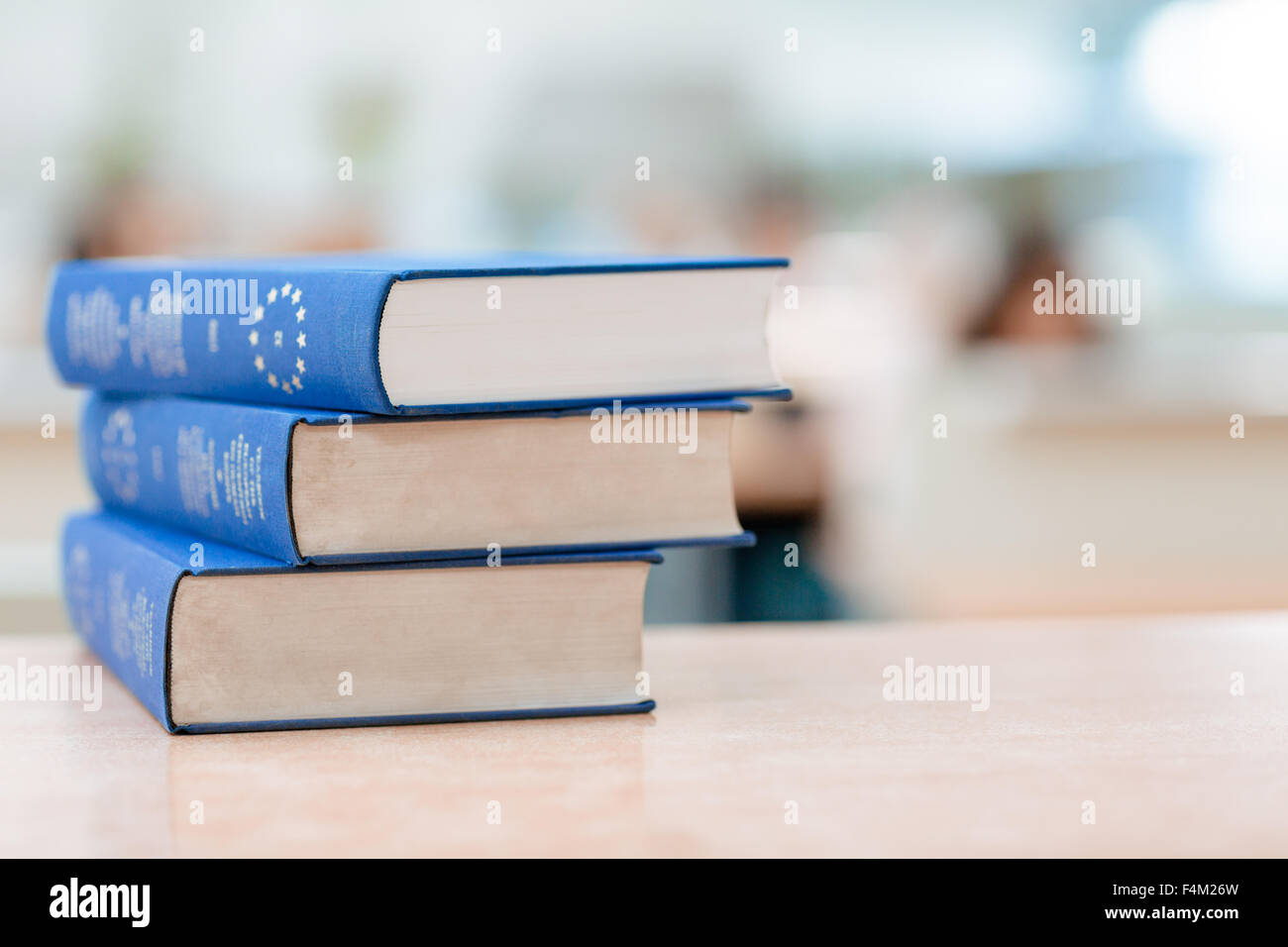 Three blue books are lying on the table Stock Photo - Alamy