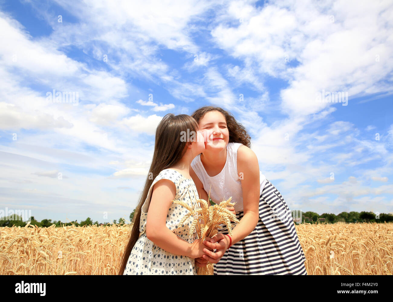 Happy family moments - Young girls having fun ln the wheat field Stock ...