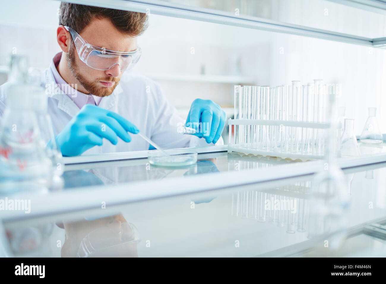 Male chemist carrying out scientific experiment in laboratory Stock ...
