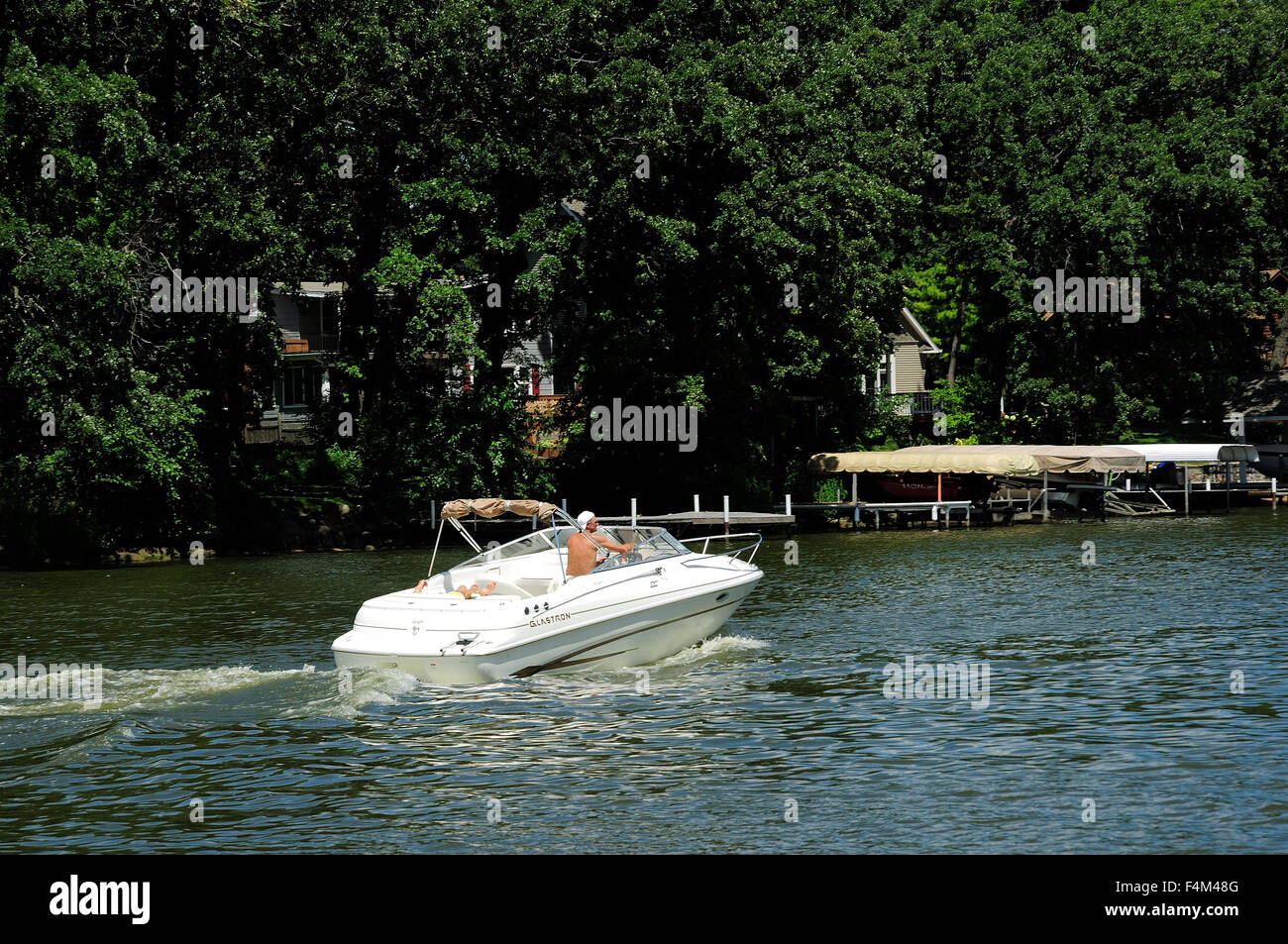 Powerboat cruising river in summer Stock Photo - Alamy