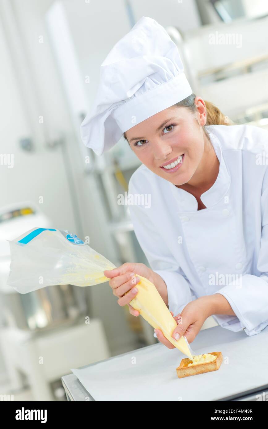 Patisserie chef piping cream onto dessert Stock Photo - Alamy