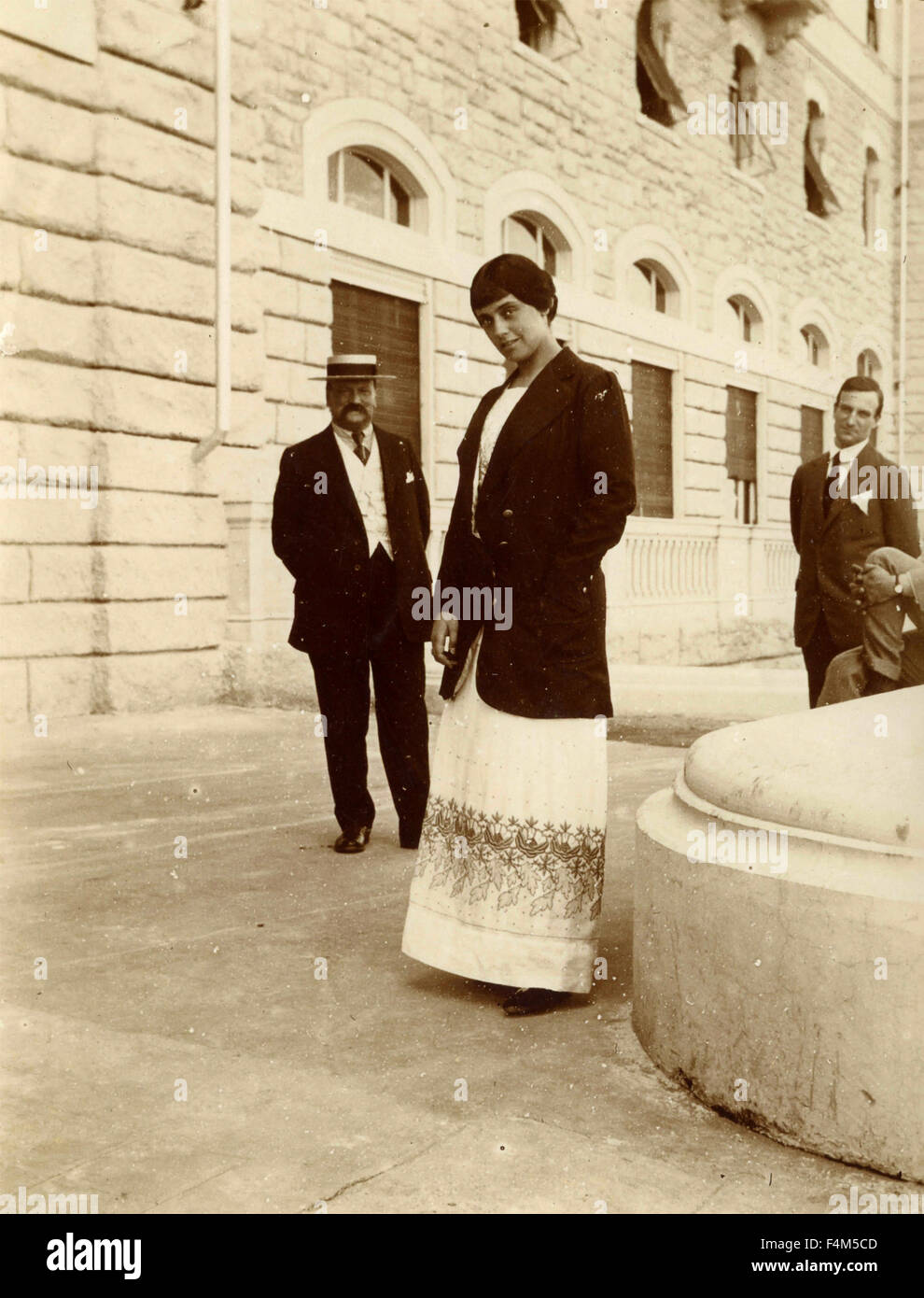 A woman with two men on the street, Italy Stock Photo - Alamy
