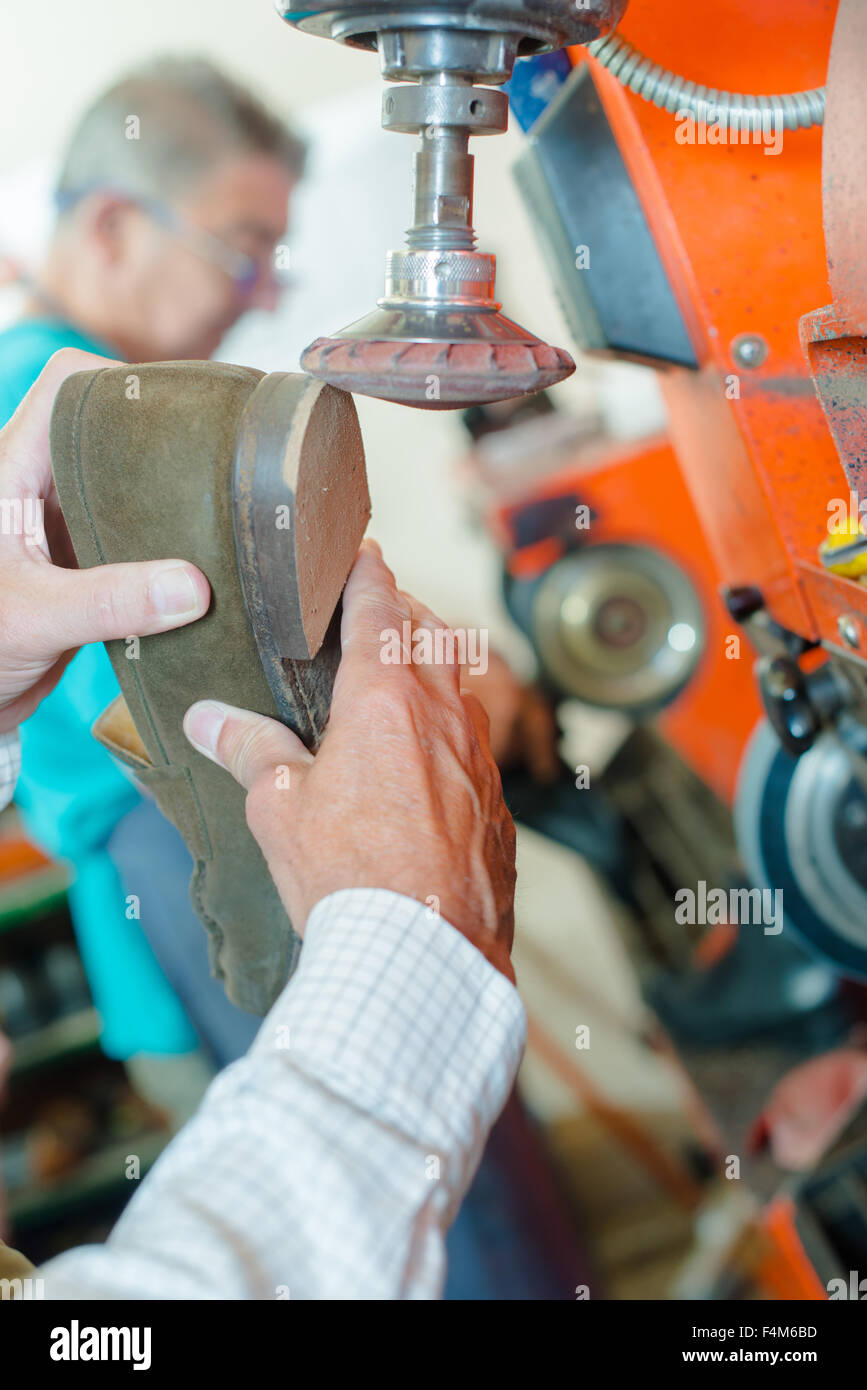 Shoemaker adjusting a heel Stock Photo - Alamy