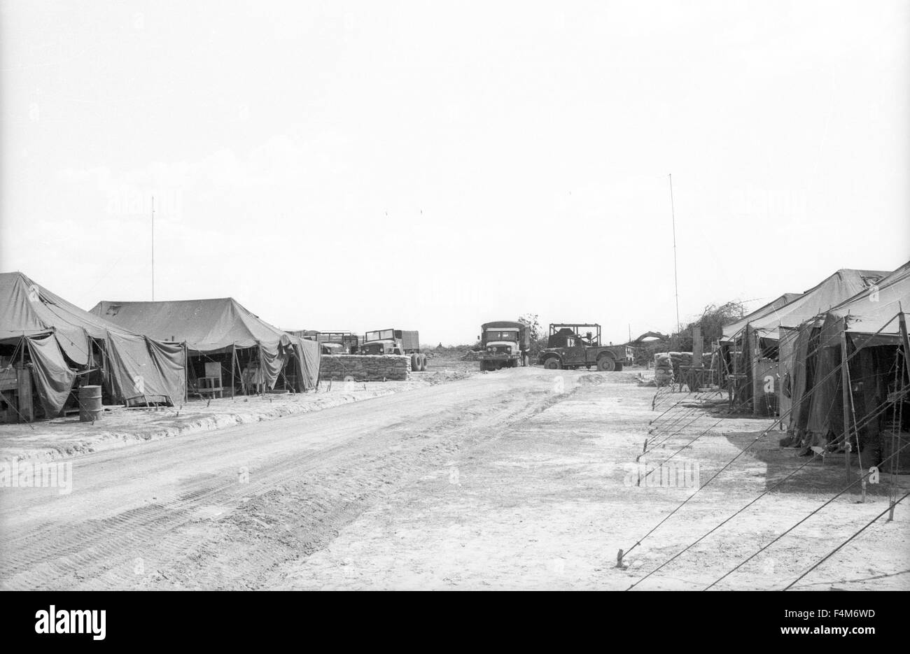 Tents and two ton trucks at a First Infantry Division base camp in 1965 ...