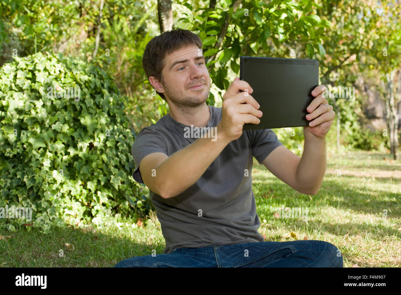 Man taking picture tablet outdoors hi-res stock photography and images ...