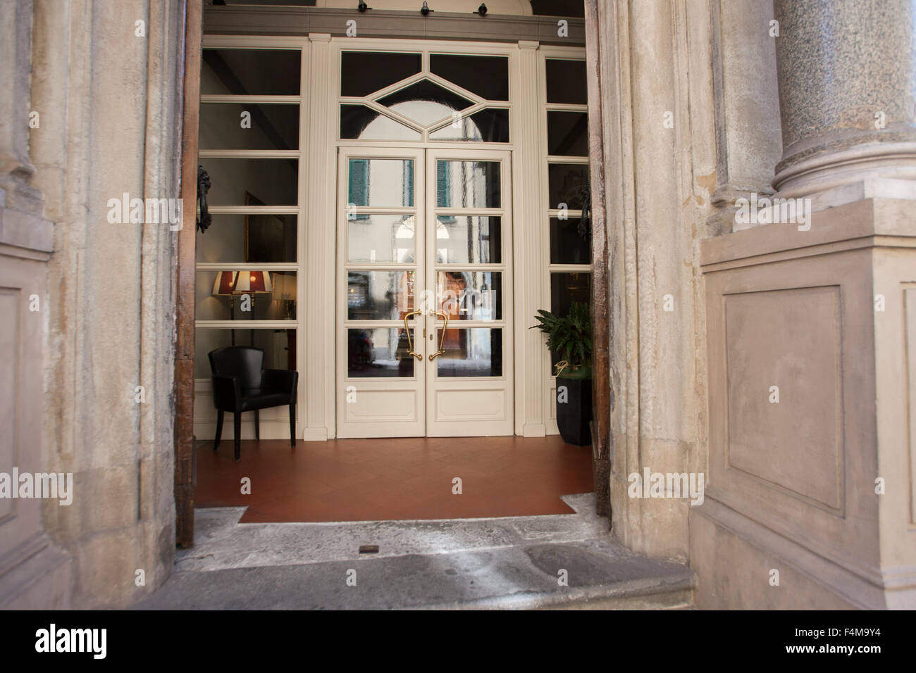 concierge looking through hotel entrance door Florence Italy Stock ...