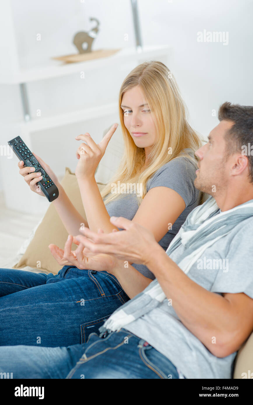 Couple arguing over remote control Stock Photo - Alamy