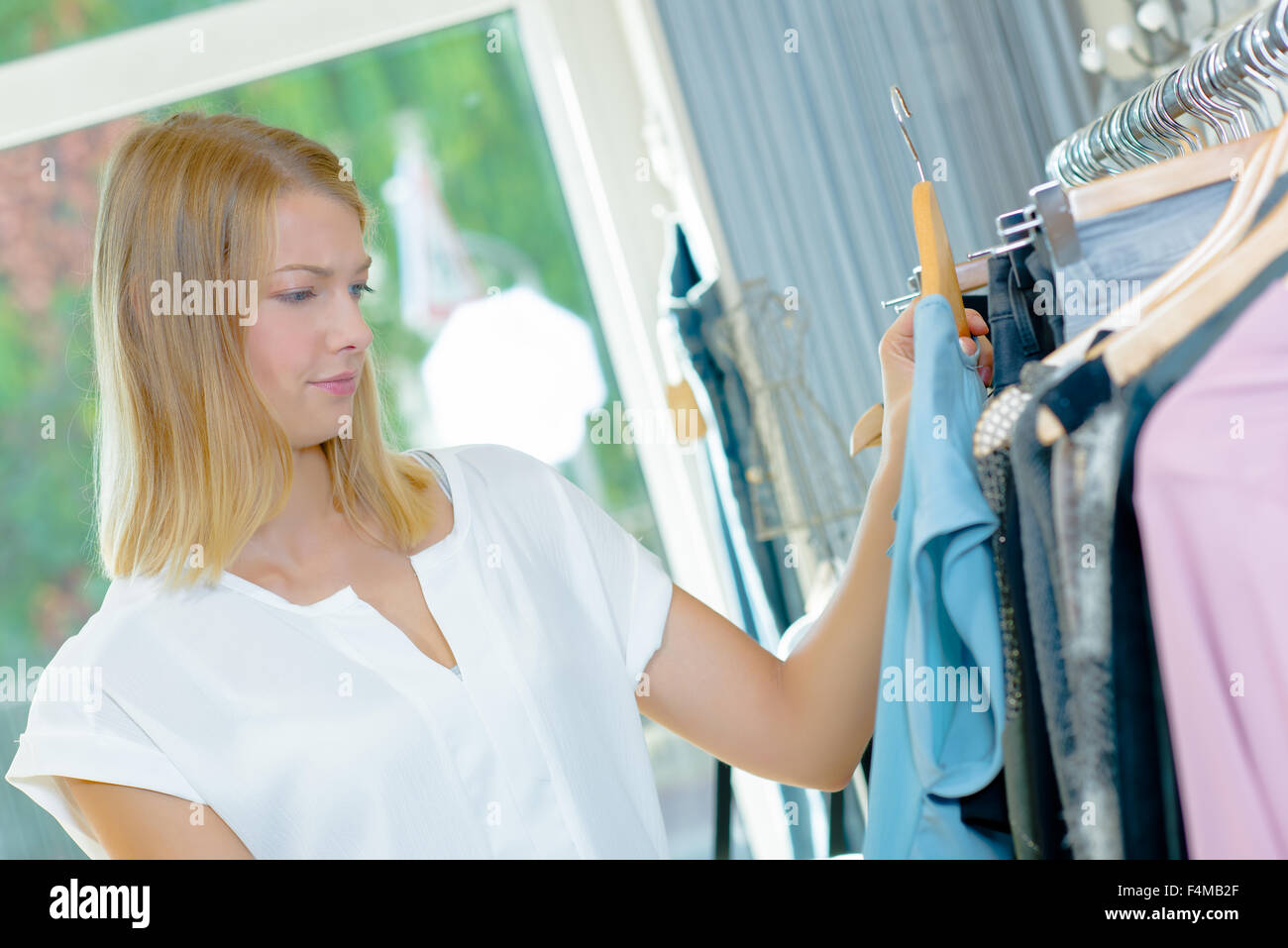 Lady browsing in a clothes shop Stock Photo - Alamy