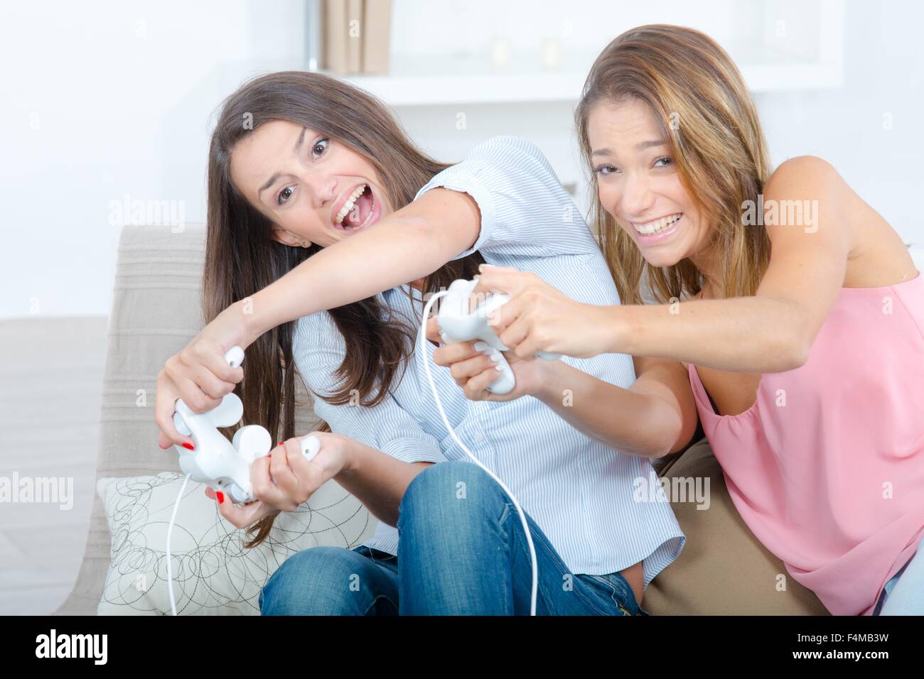 Two girls playing computer game Stock Photo - Alamy