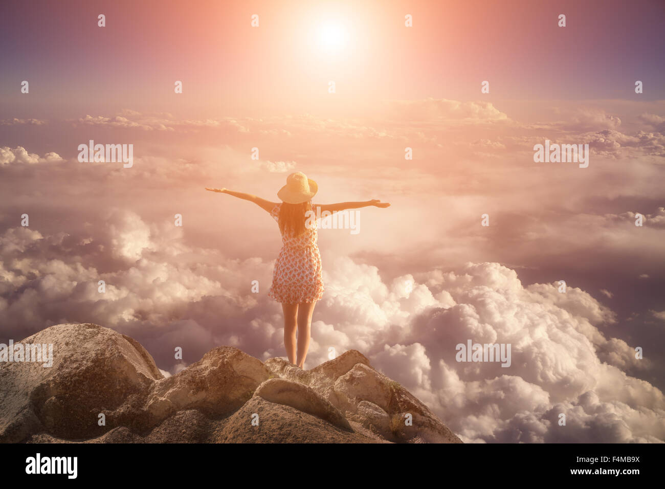 freedom young woman jumping on mountain peak rock Stock Photo - Alamy