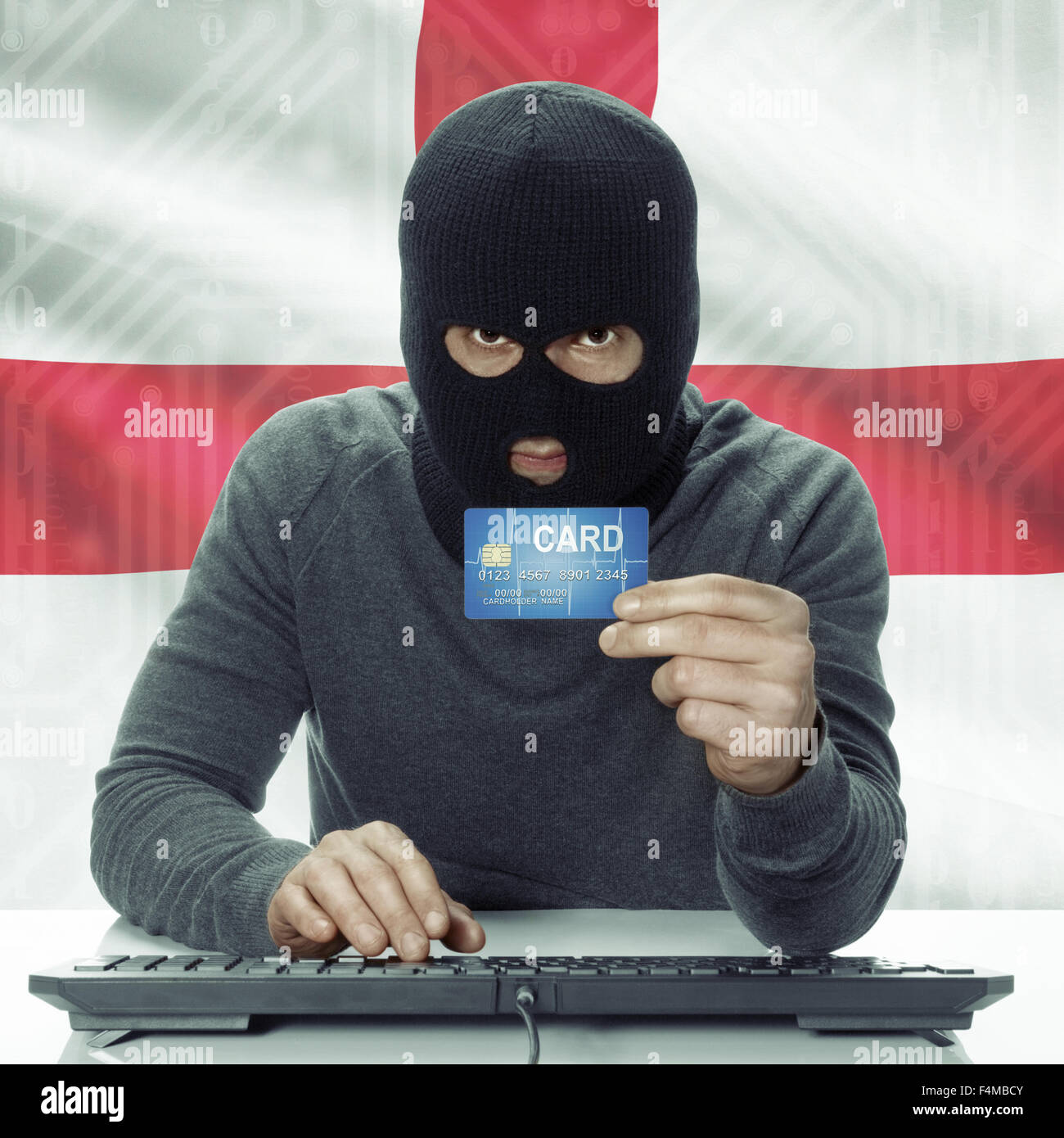 Dark-skinned hacker with credit card in hand and flag on background ...