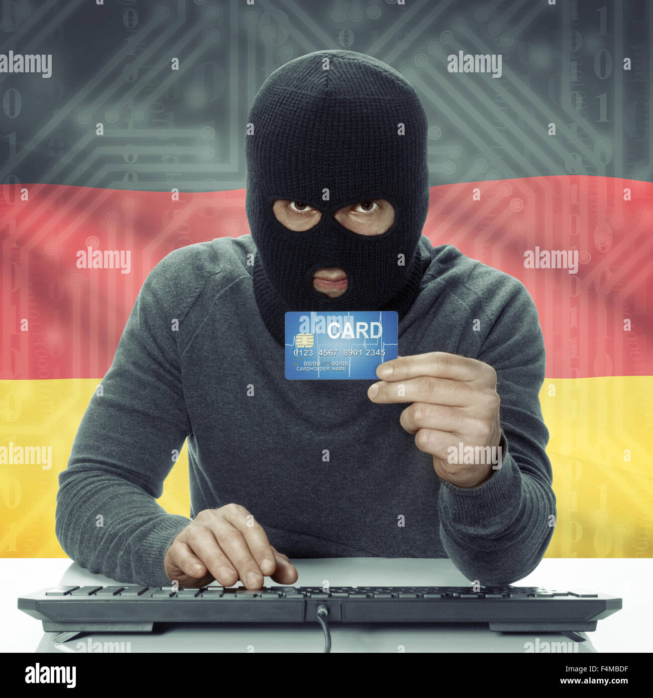 Dark-skinned hacker with credit card in hand and flag on background ...