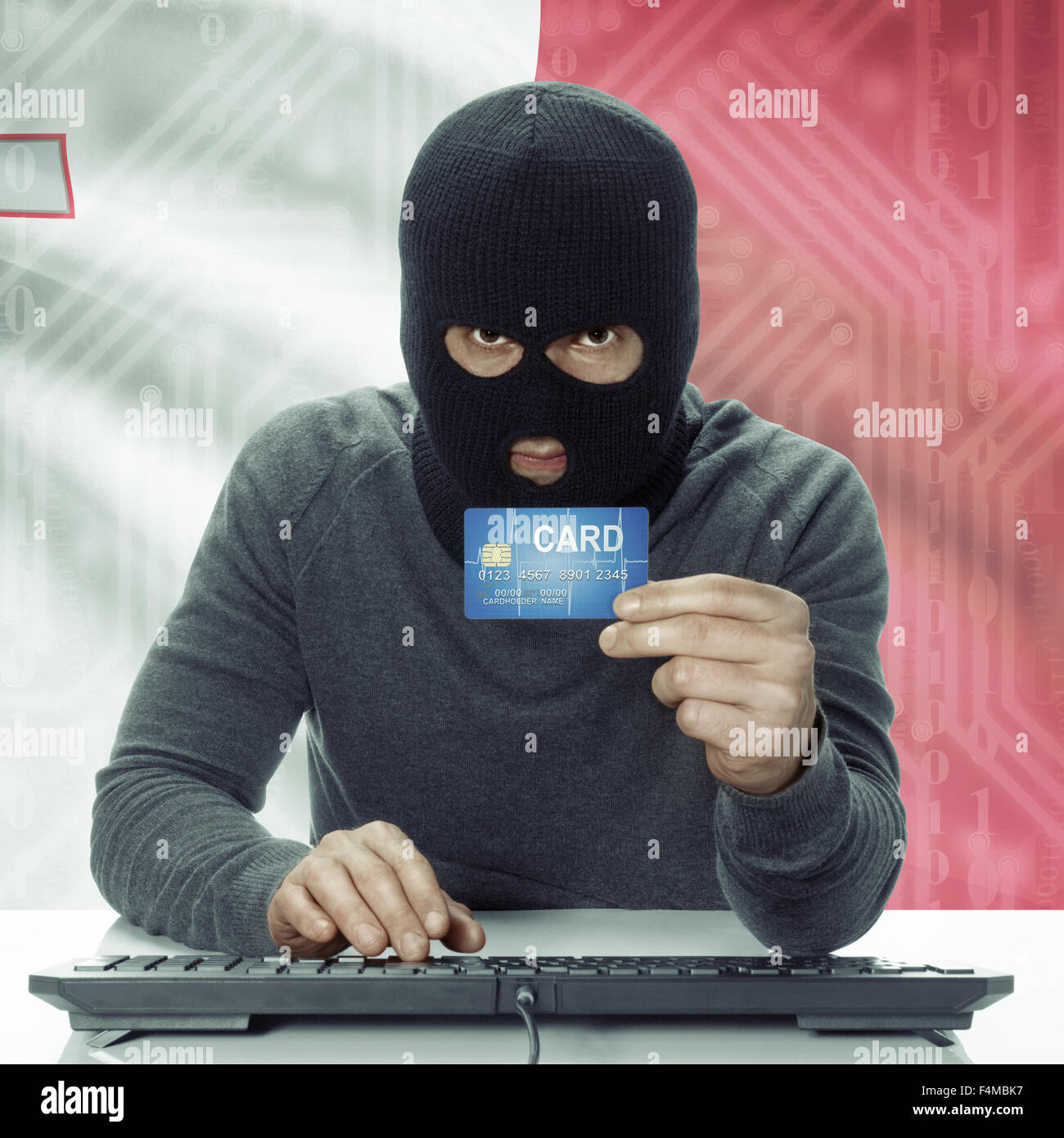 Dark-skinned hacker with credit card in hand and flag on background ...