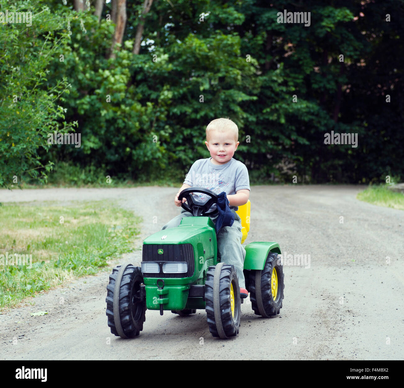 Young boy with toy tractor Stock Photo - Alamy