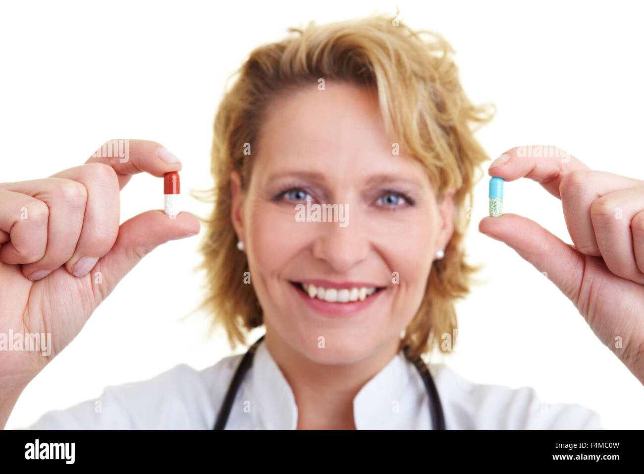 Female doctor holding a red and a blue pill Stock Photo - Alamy