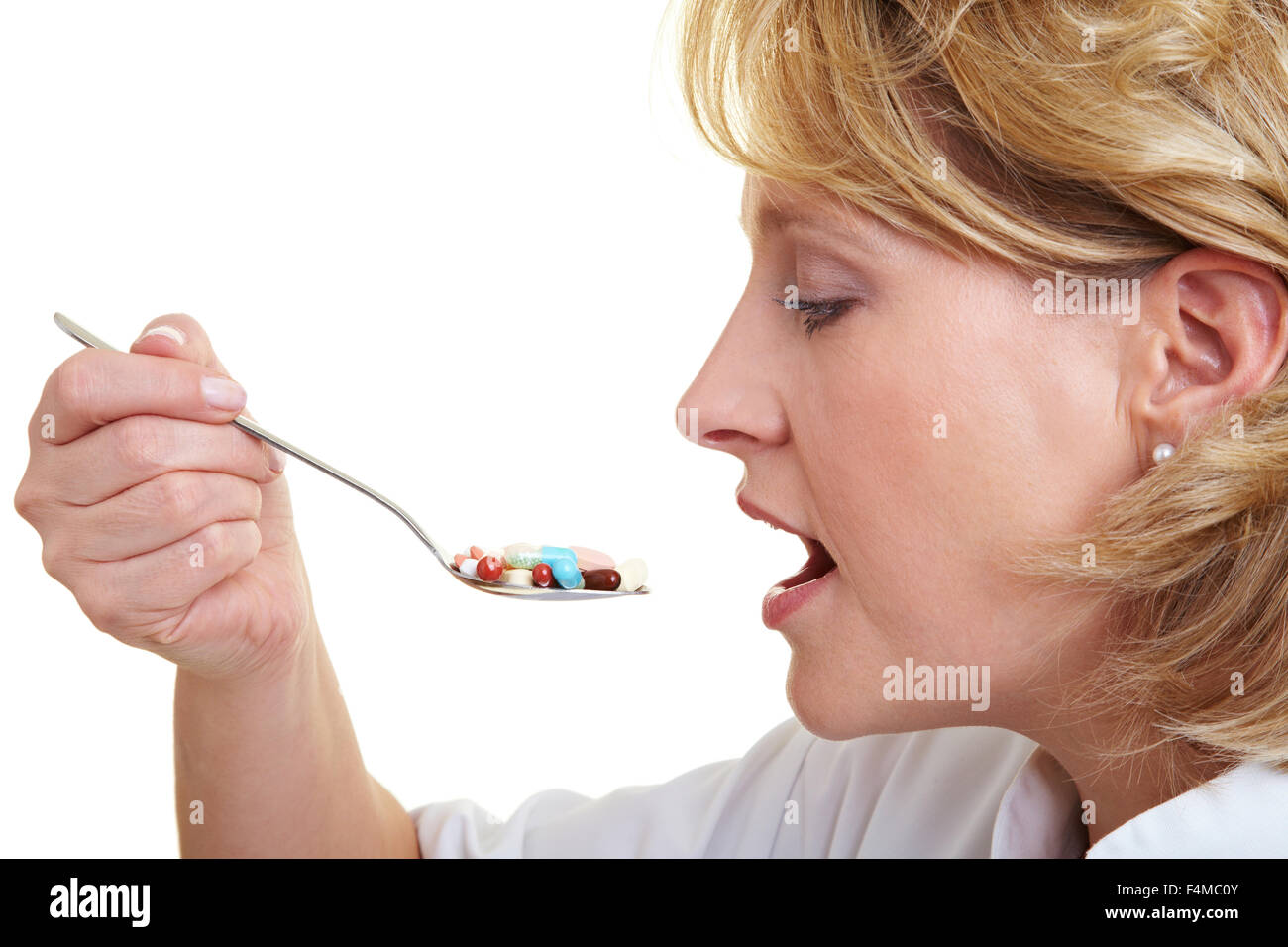 Woman eating pills 50 hi-res stock photography and images - Alamy