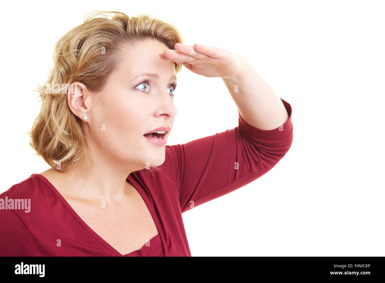 A woman holding her hand on her forehead Stock Photo - Alamy