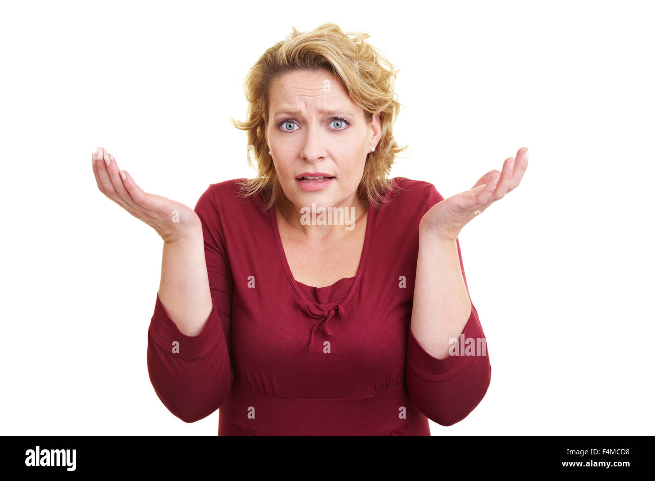 Clueless woman shrugging helpless with her shoulders Stock Photo - Alamy