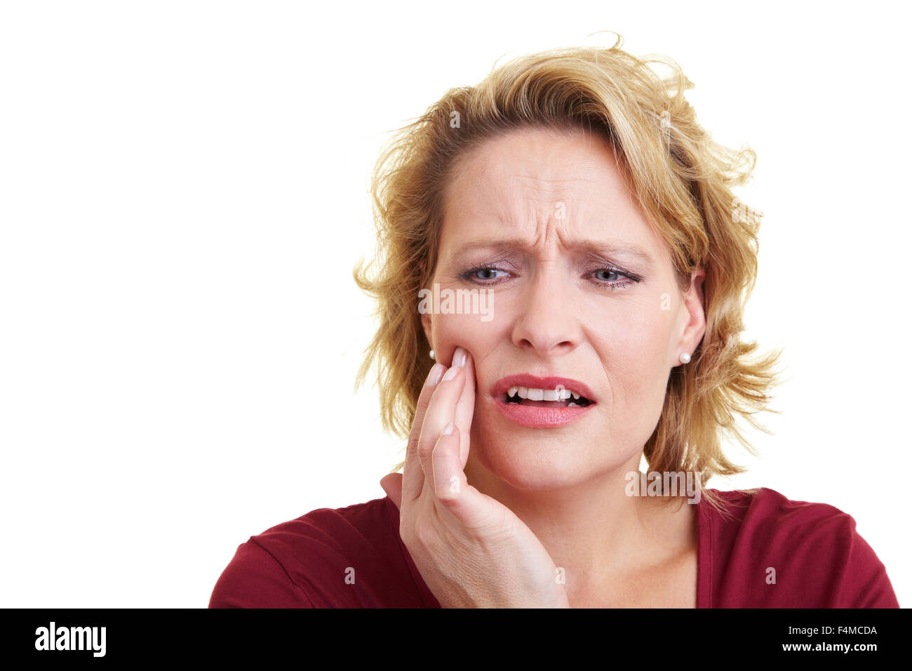 Woman holding her hand on her aching tooth Stock Photo - Alamy