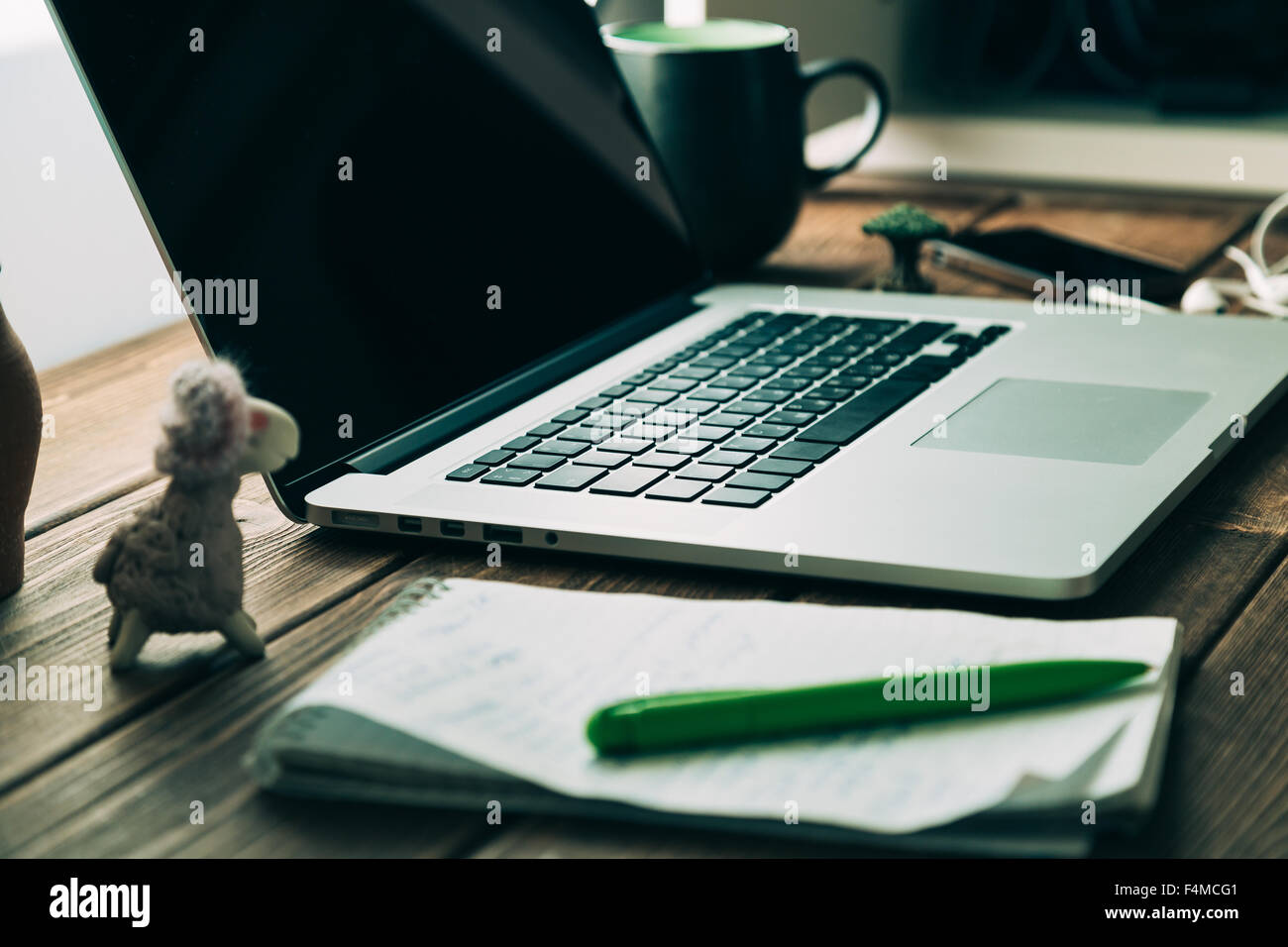 Workplace with open laptop on modern wooden desk Stock Photo - Alamy