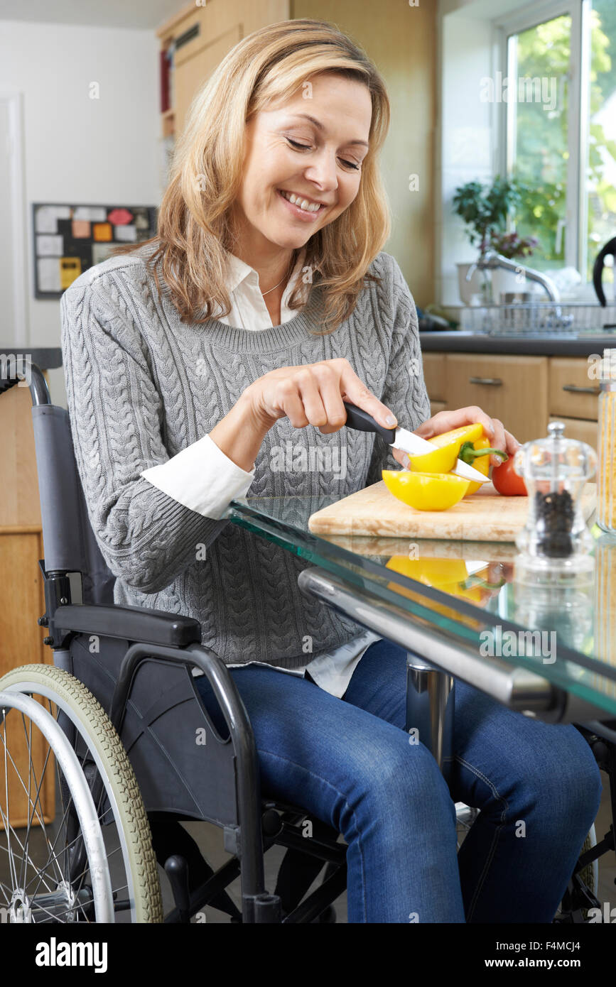 Disabled Woman In Wheelchair Preparing Meal In Kitchen Stock Photo - Alamy