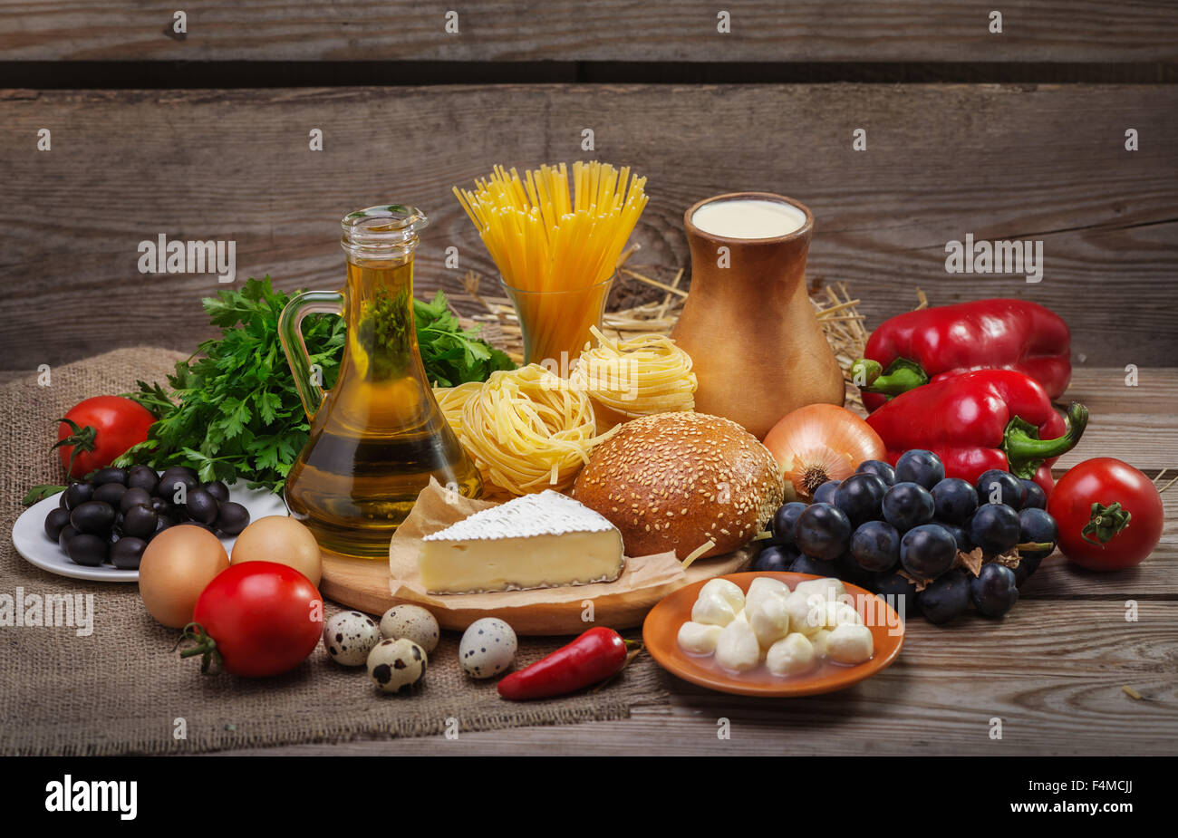 Set of different foods on the old wooden background, vegetables, pasta ...