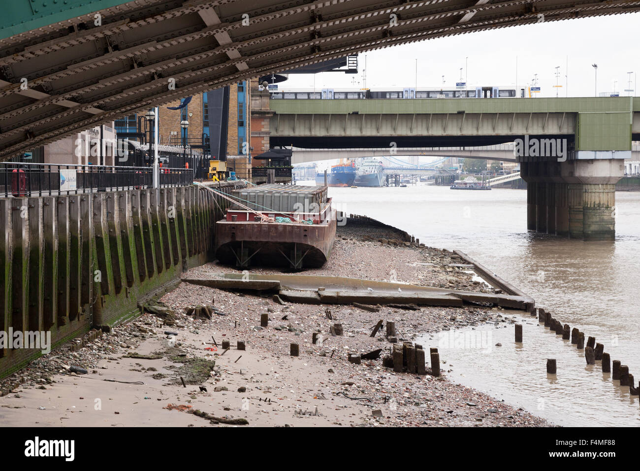 A barge used for waste disposal awaits the high tide on London's River ...
