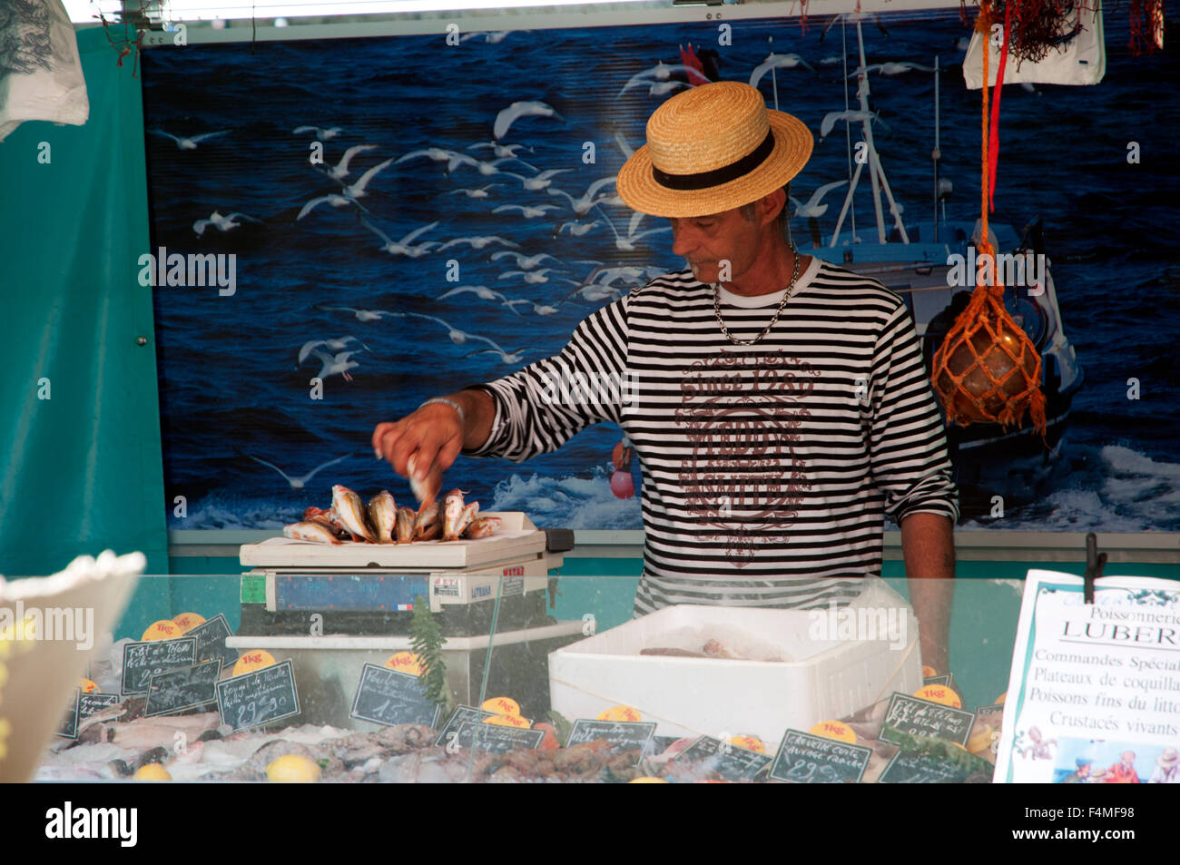 Fish merchant on market stall in Provence France Europe deaer trader ...