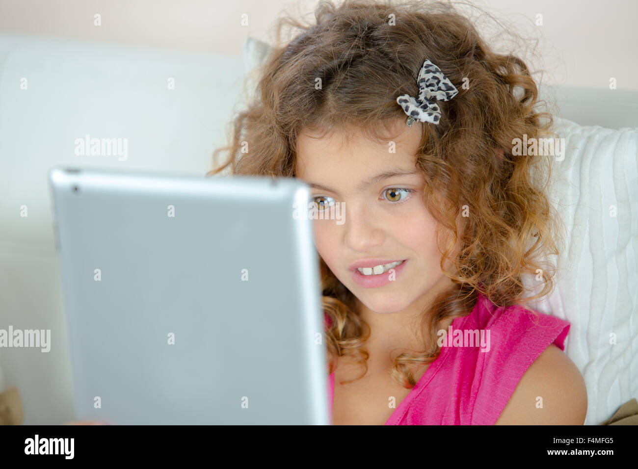 Little girl using her tablet computer Stock Photo - Alamy