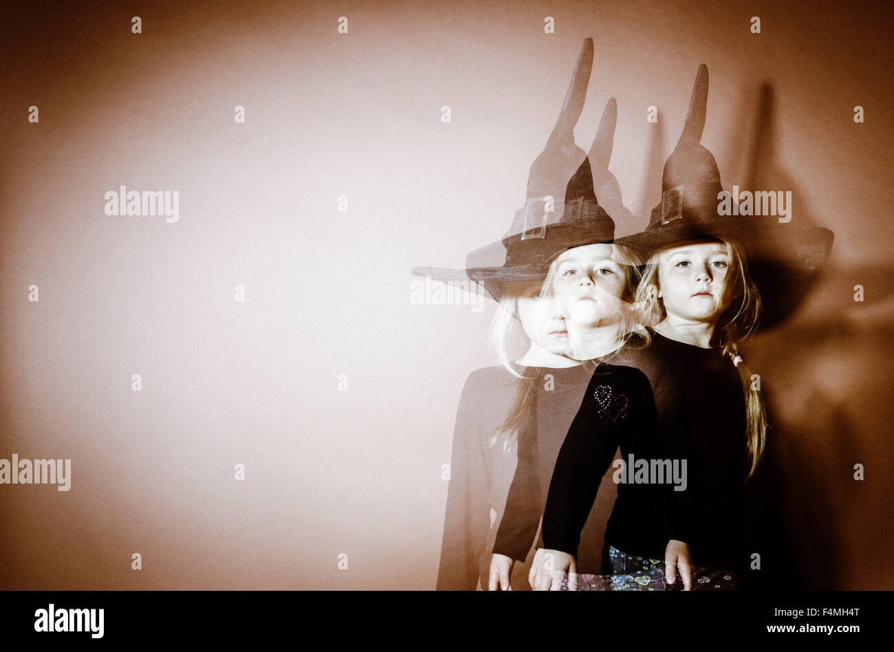 Halloween mystic photo with mixed light. Cute little girl multi ...