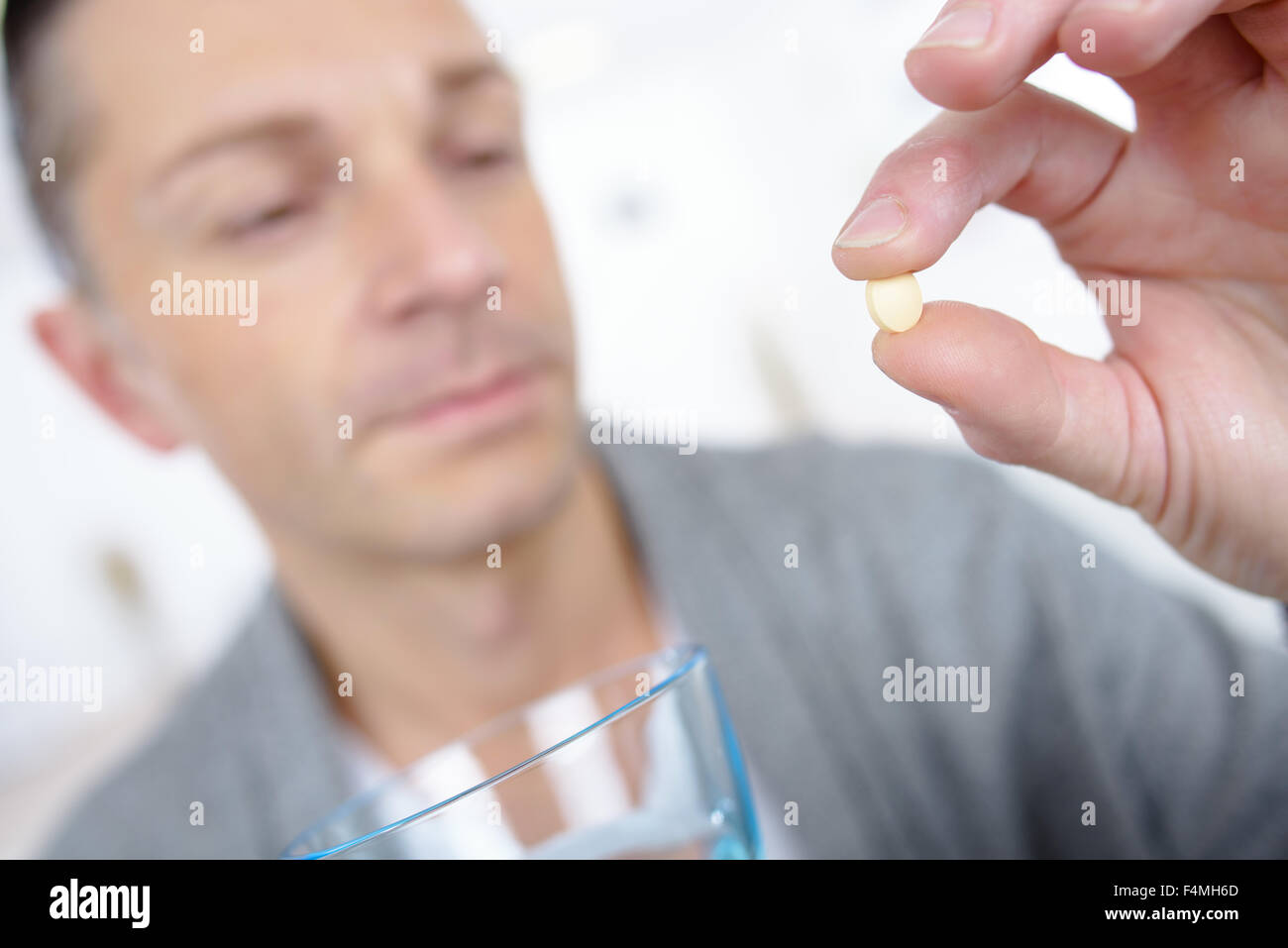 Man headache taking tablet hi-res stock photography and images - Alamy