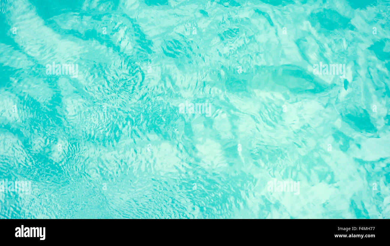 The blue surface of tropical ocean water creates an abstract pattern ...