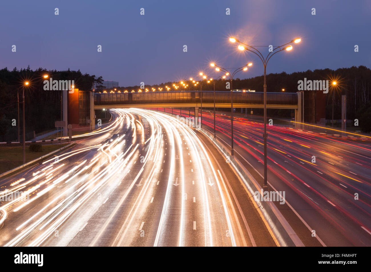 Illuminated highway at evening with light trails Stock Photo - Alamy