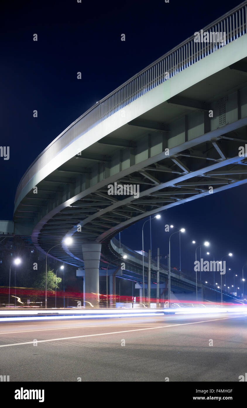Overpass and light trails at night on the illuminated highway Stock ...