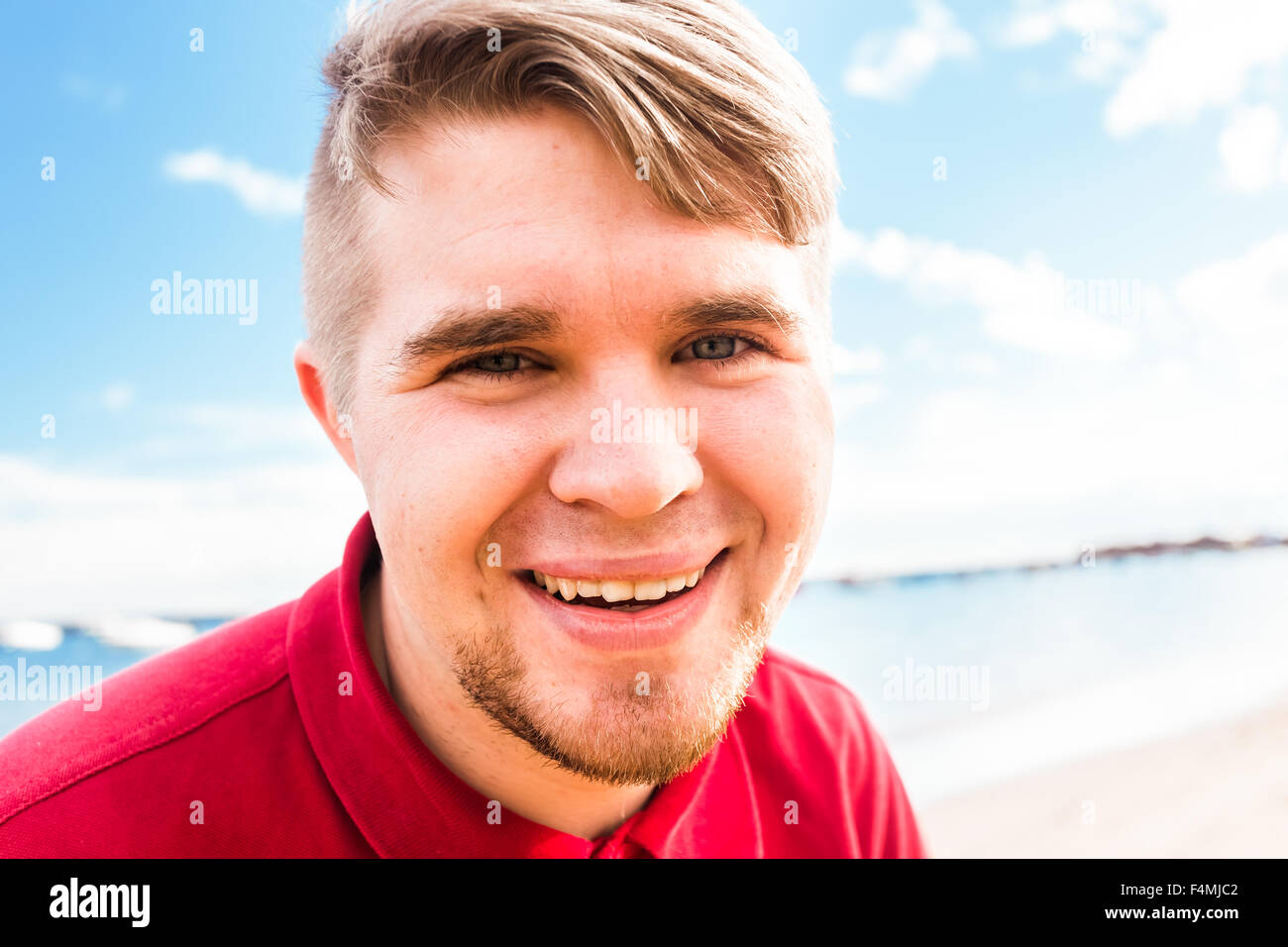 Smiling man at the beach Stock Photo - Alamy