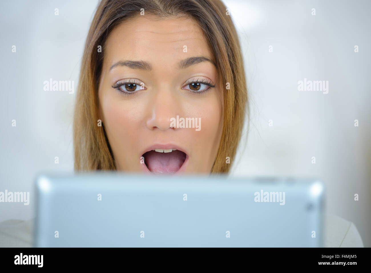 Surprised woman on computer Stock Photo - Alamy