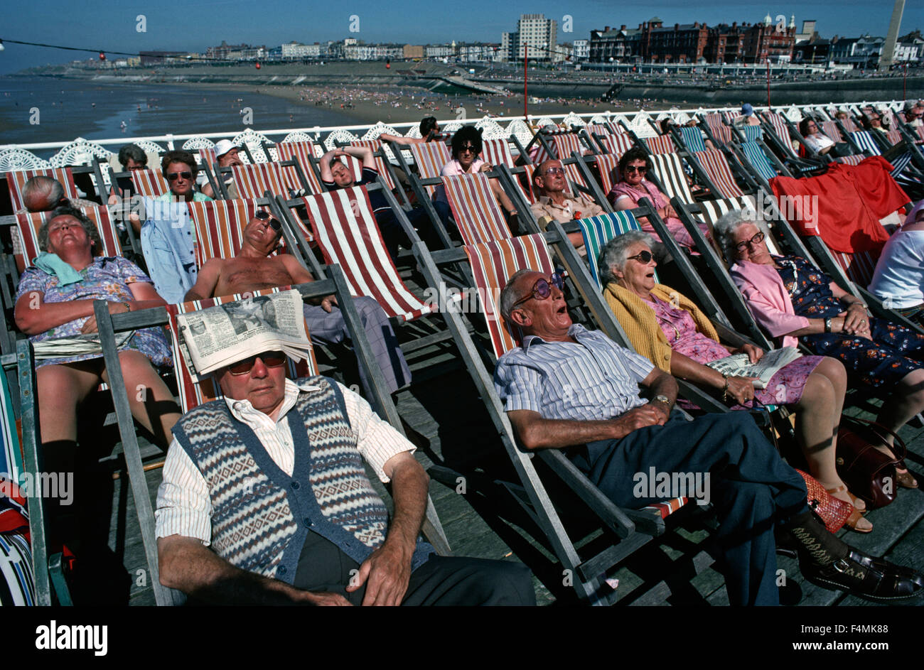 August Bank holiday makers sunbathing in deckchairs on Blackpool North ...