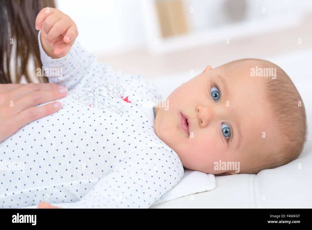 Baby lying on its back Stock Photo - Alamy