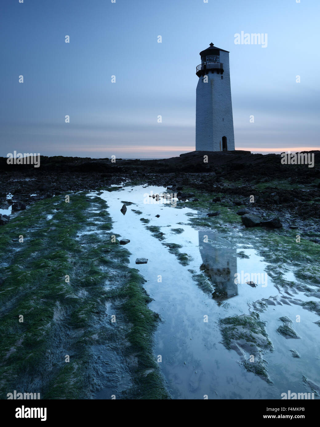 The stunning white, square, Southerness Lighthouse at Sunset reflecting ...