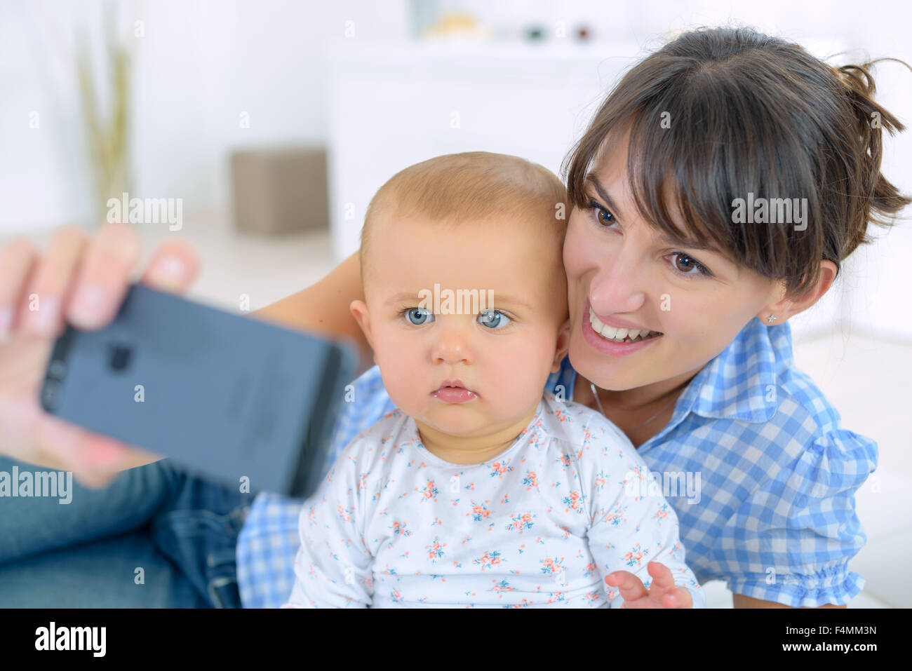 Woman taking a self photo of her baby Stock Photo - Alamy