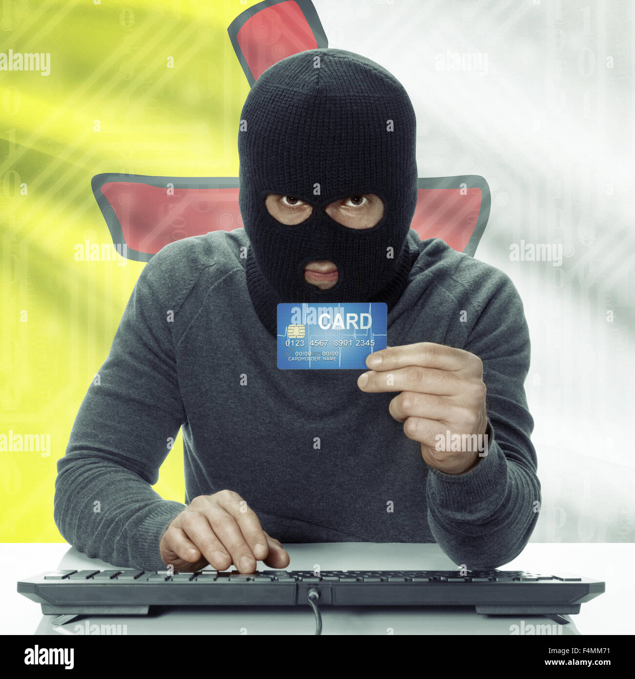 Dark-skinned hacker holding credit card with Canadian province flag on ...