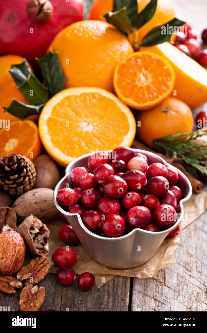 Fall and winter ingredients still life with oranges, cranberry, nuts ...