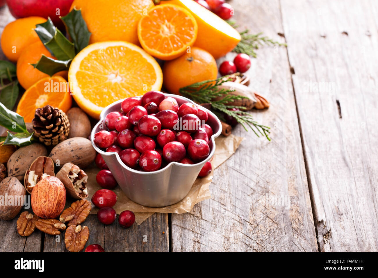 Fall and winter ingredients still life with oranges, cranberry, nuts ...