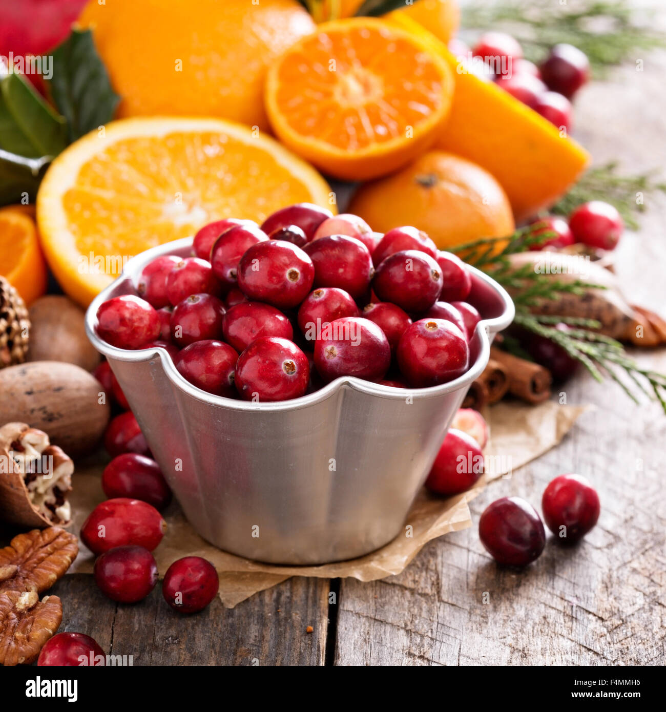Fall and winter ingredients still life with oranges, cranberry, nuts ...