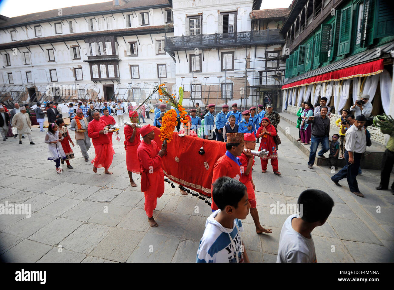 Nepalese priest carrying Fulpati towards Dashain Ghar (house) after ...