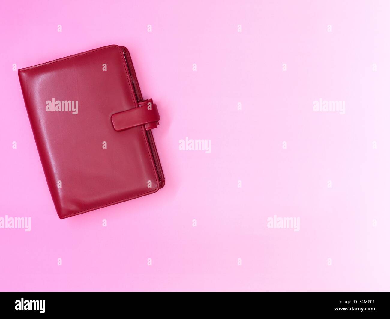 A red leather business notebook binder Stock Photo - Alamy